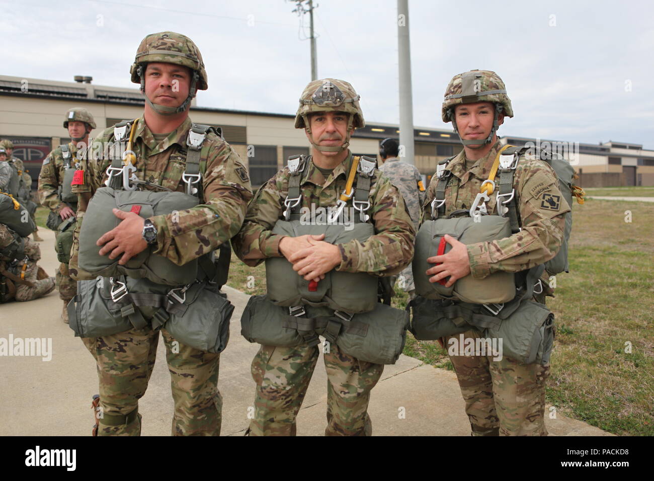 U.S. Army Command Sgt. Maj. Benjamin Jones poses for a picture with two ...