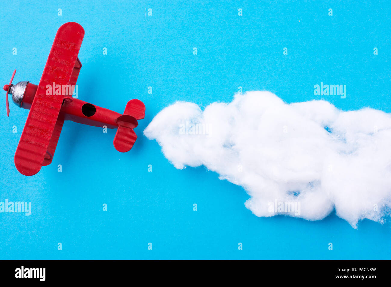 Retro styled little red model airplane in sky Stock Photo - Alamy