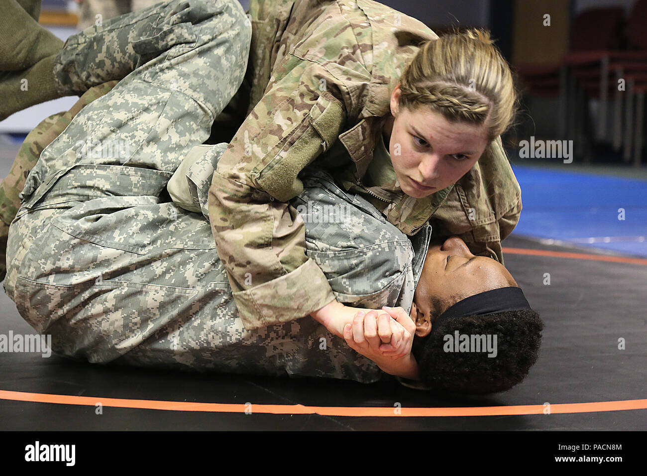 U.S. Army Sgt. Nikayla Shodeen, attempts to pass the half guard of Spc ...