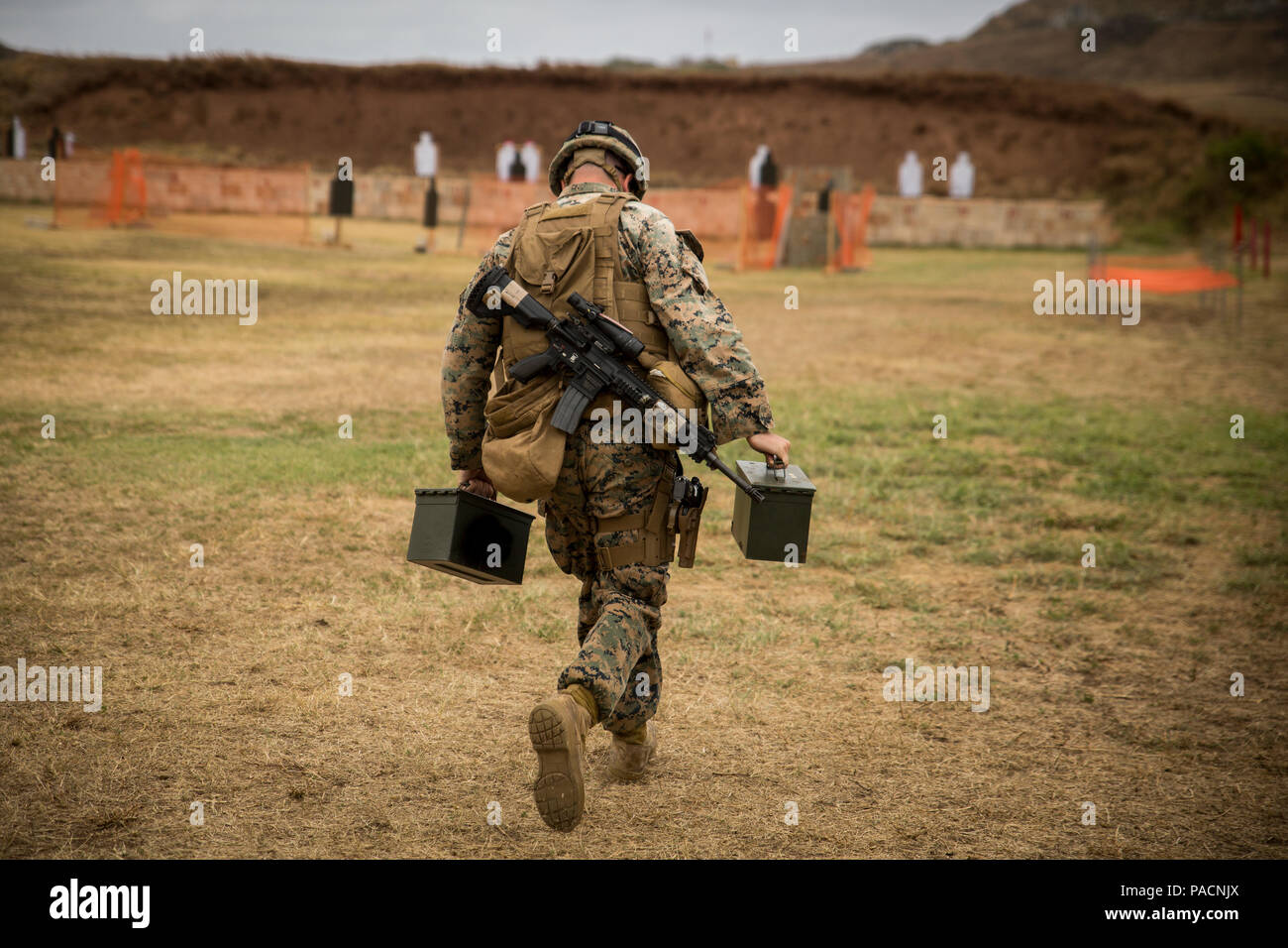 Lance Cpl. Andrew Caudill runs with ammunition cans to the next stage ...