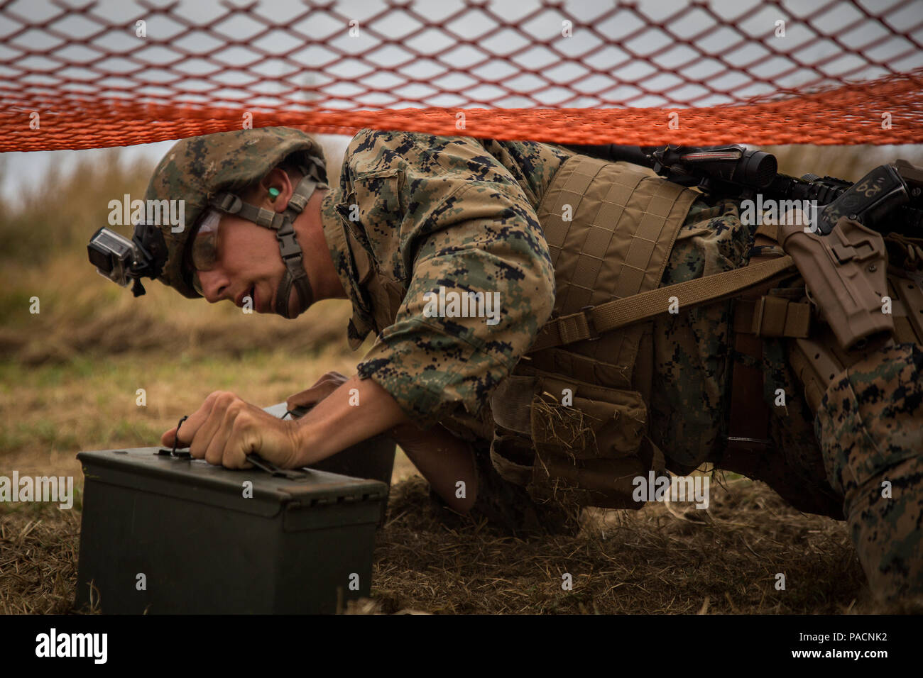 Sgt. Dalton Anonsen low crawls with ammunition cans during a course of ...