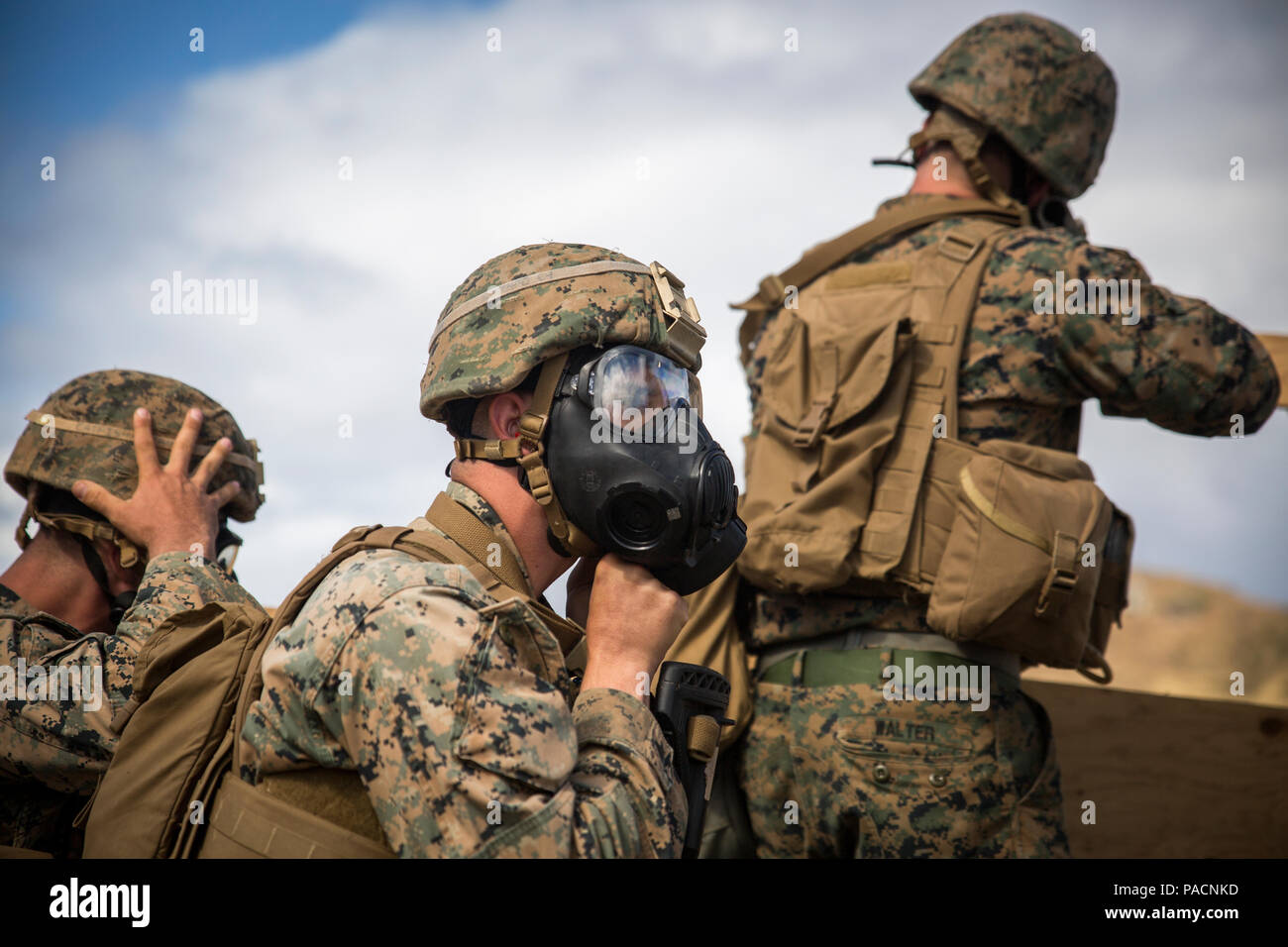 Cpl. Joseph Walter provides cover fire as Marines don their M50 ...