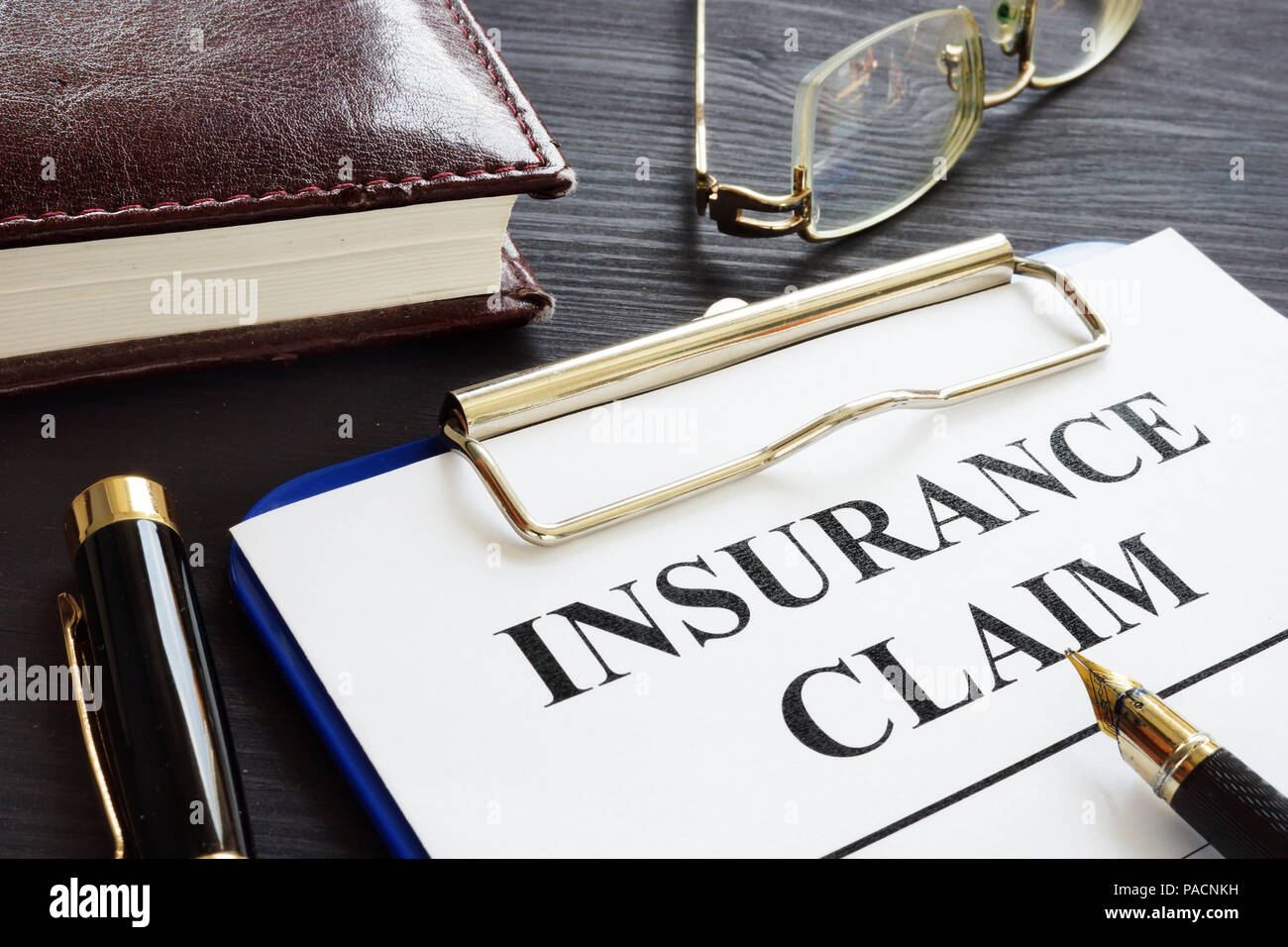 Insurance claim form and pen in the agency Stock Photo - Alamy