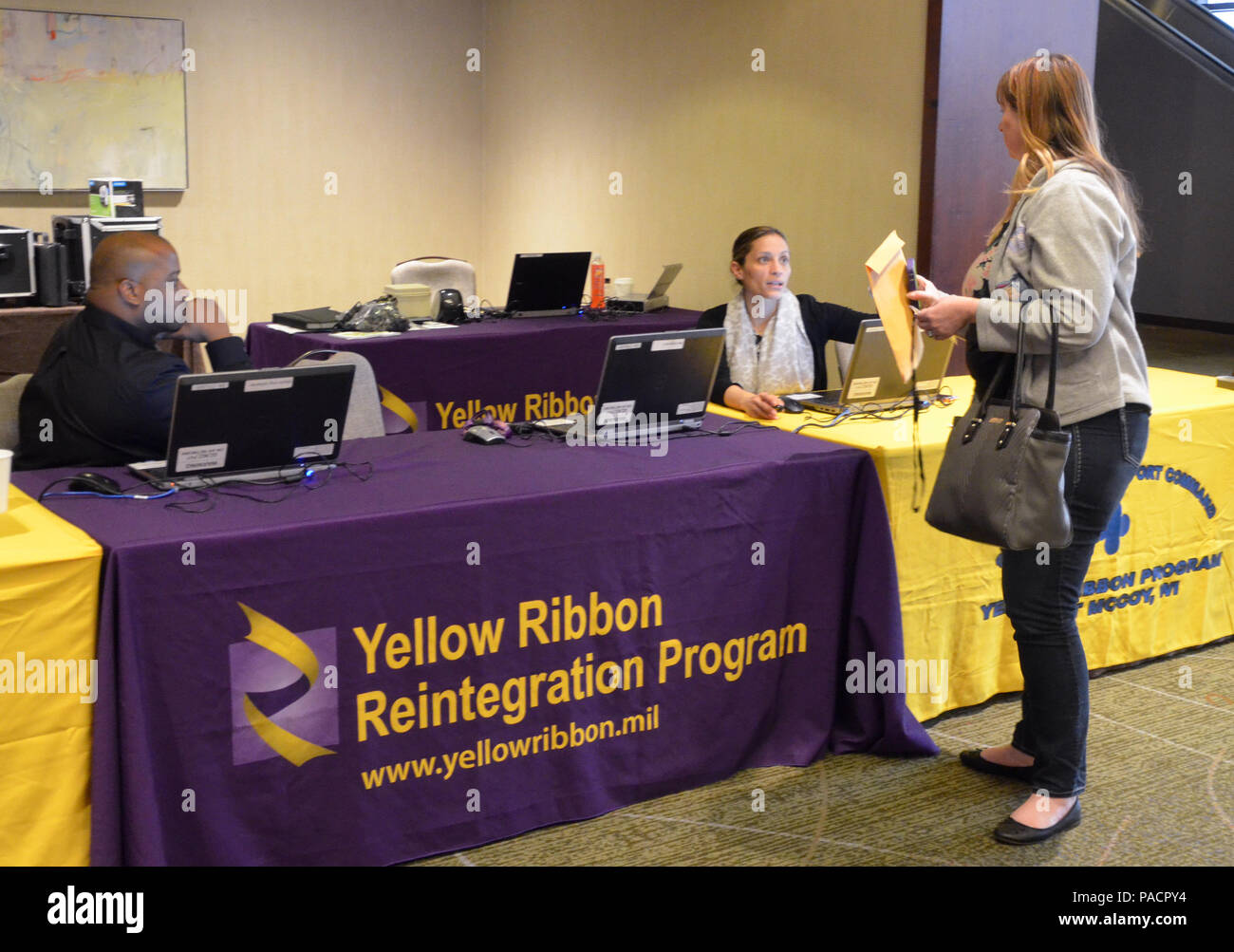 Soldiers and Family members register and receive welcome packets for ...