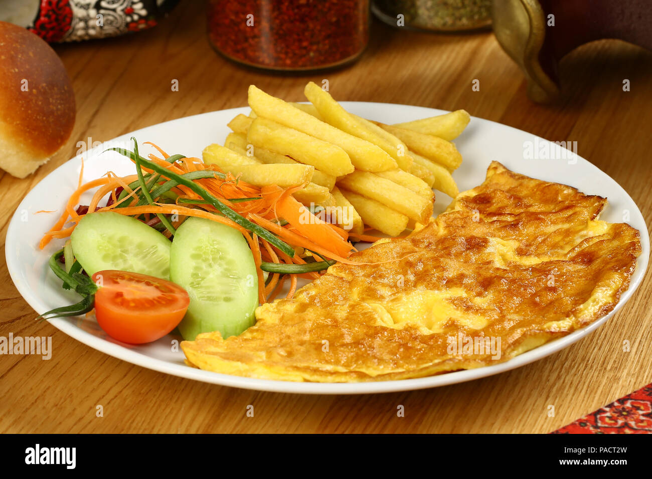 Breakfast omelette with french fries and garnish Stock Photo - Alamy