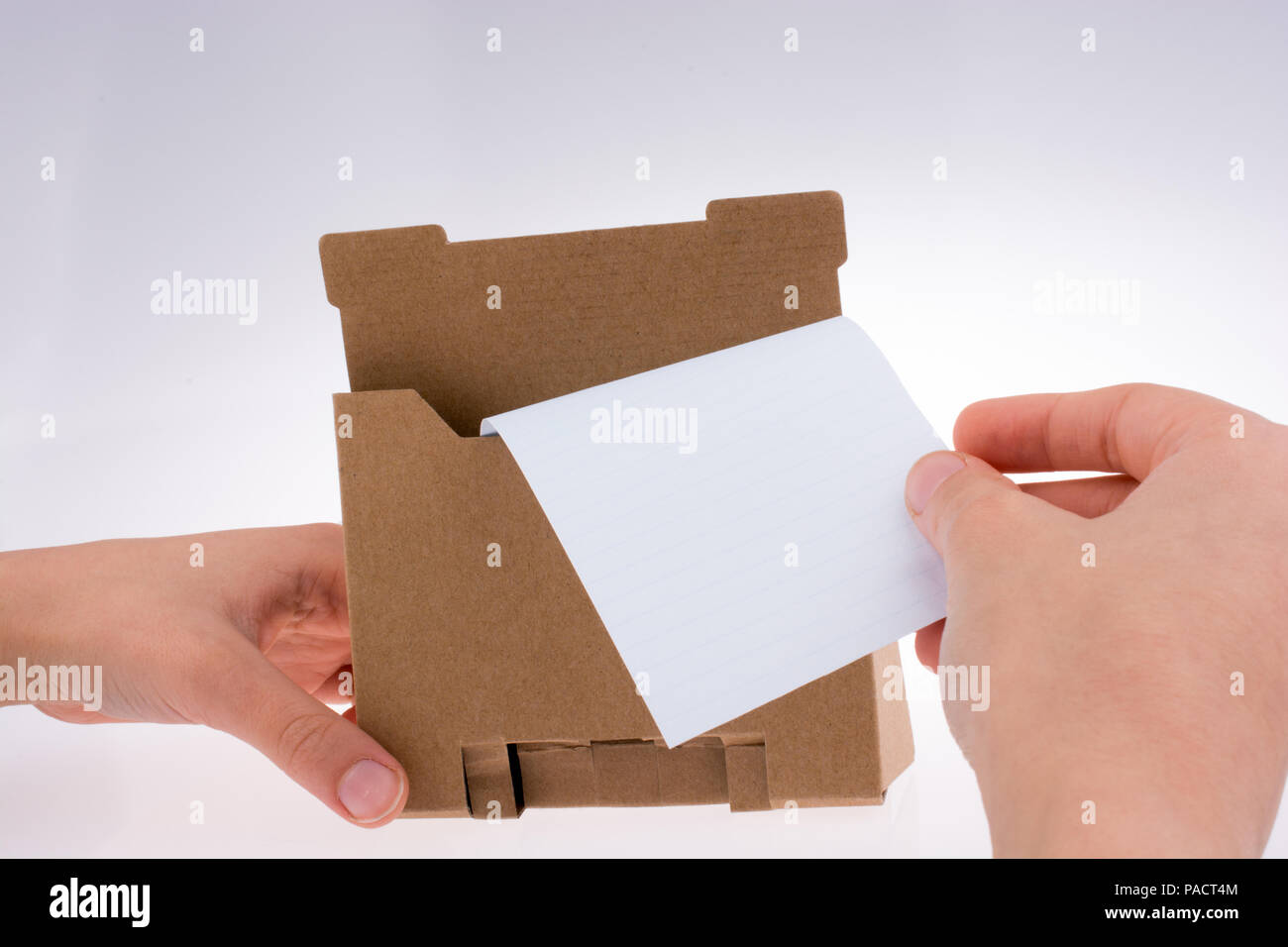 Hand reaches paper holder stand on white background Stock Photo - Alamy