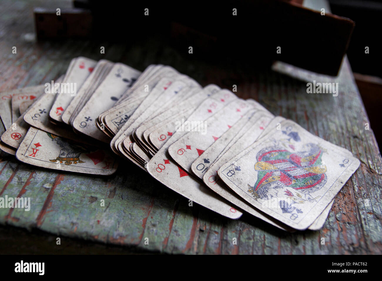 Playing cards on a rustic wooden table Stock Photo - Alamy