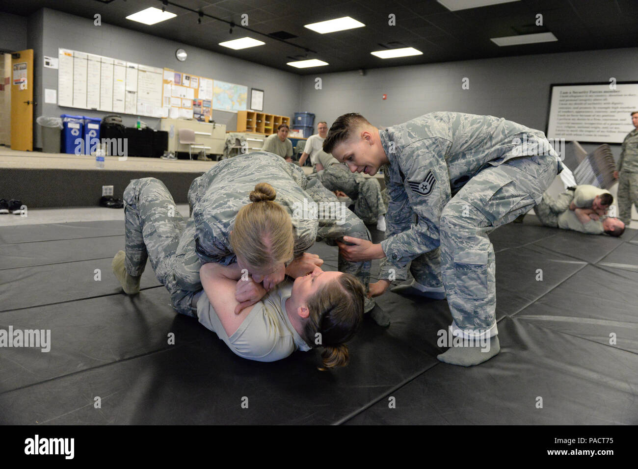 U.S. Air Force combatives instructor Staff Sgt. Lacey Bunkelman, right ...