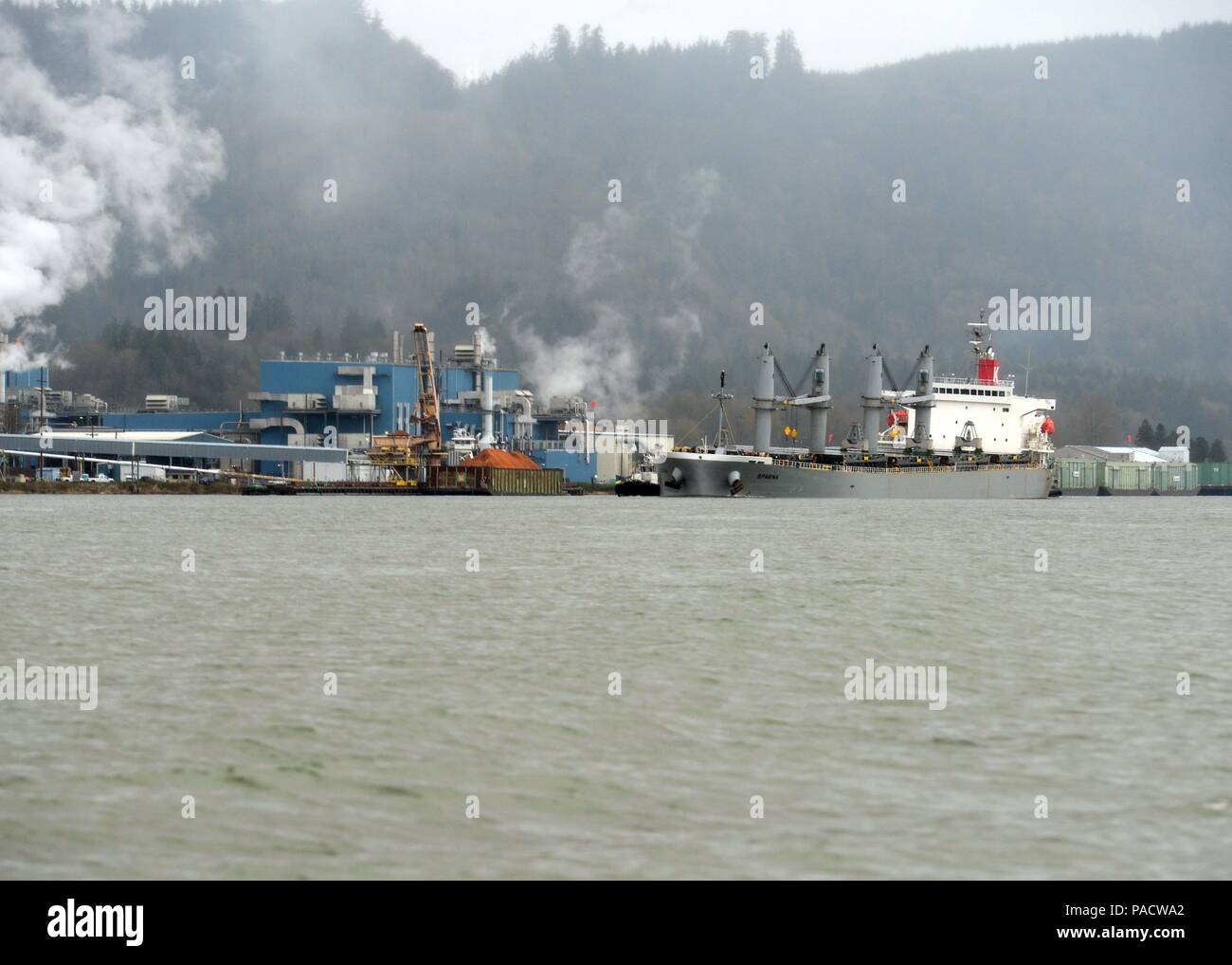 Two tugs support the 623-foot motor vessel Sparna past the Wauna Paper ...