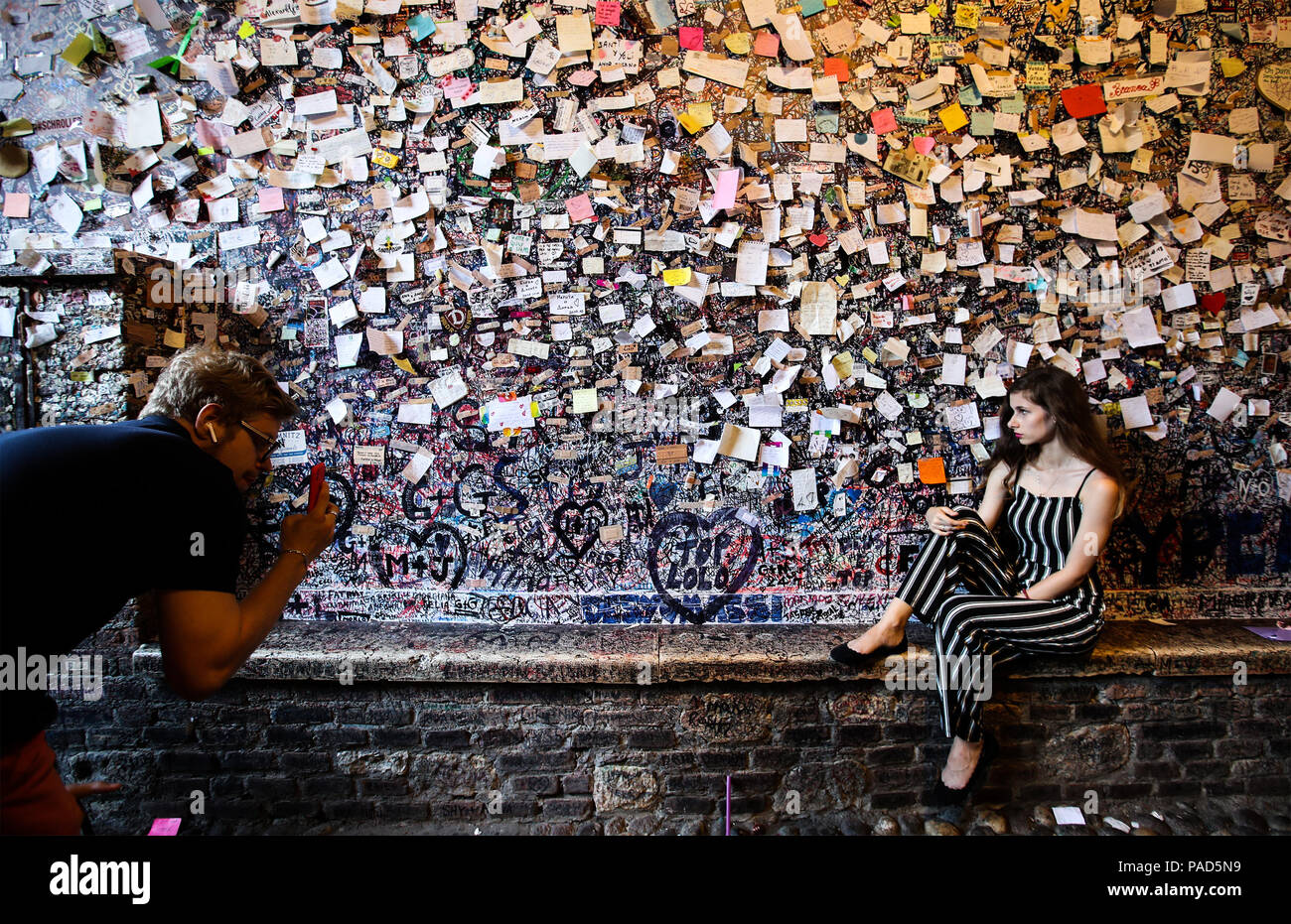 Verona, Italy. 20th July, 2018. A woman poses for photos with the ...