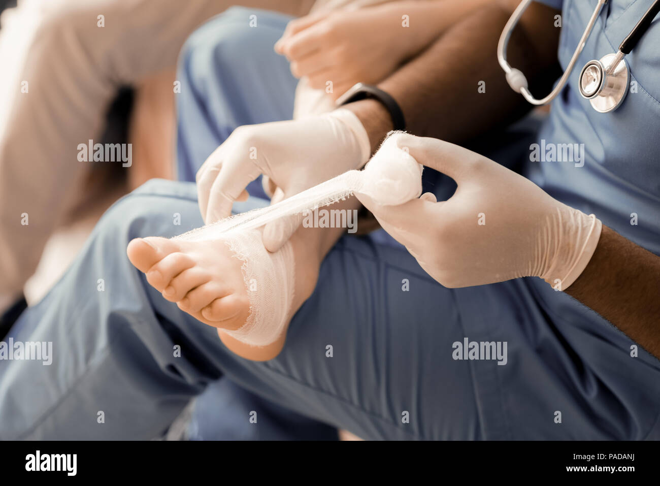Professional medical worker dressing little foot Stock Photo - Alamy