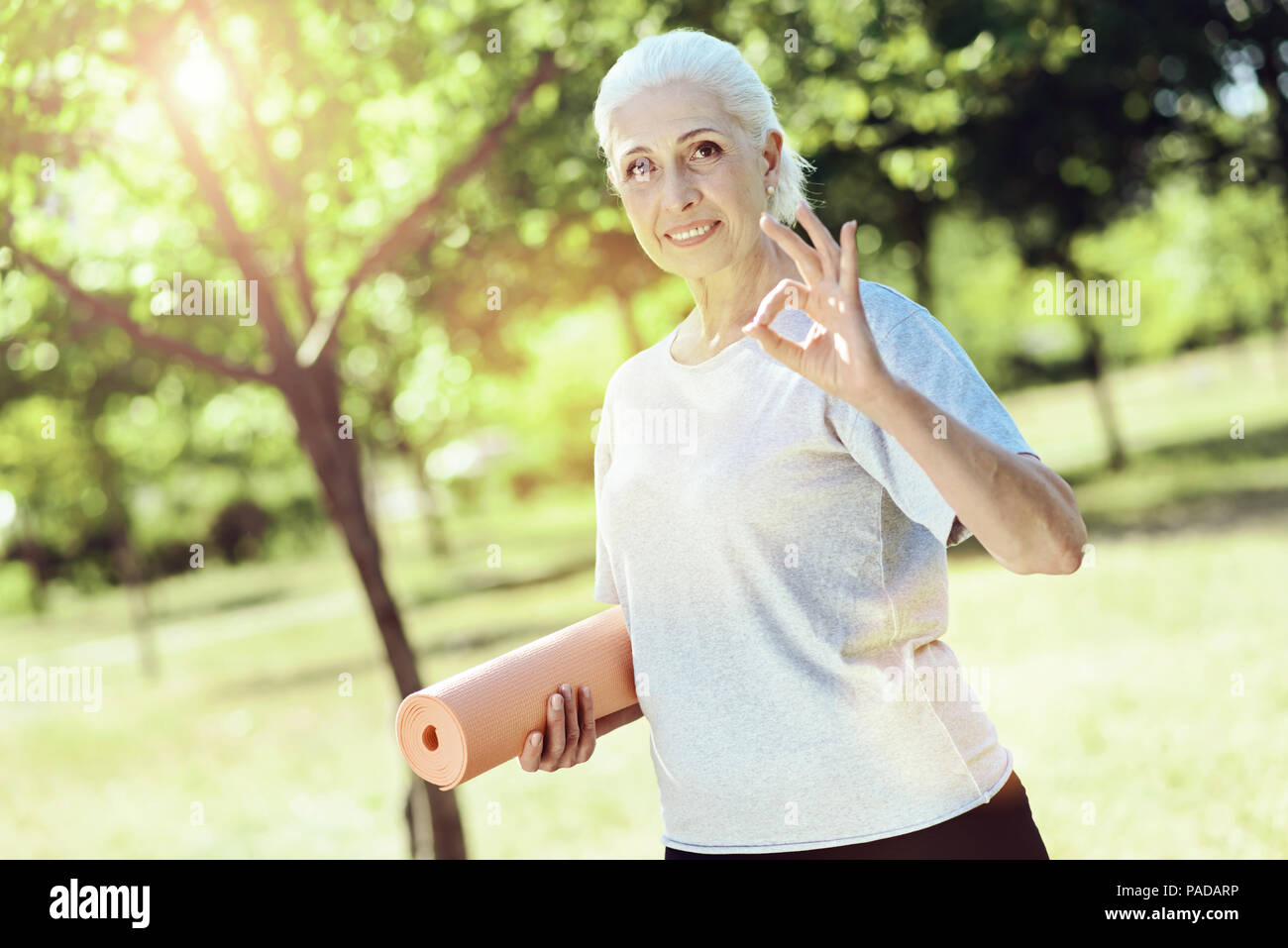 Cheerful elderly lady showing her good mood Stock Photo - Alamy
