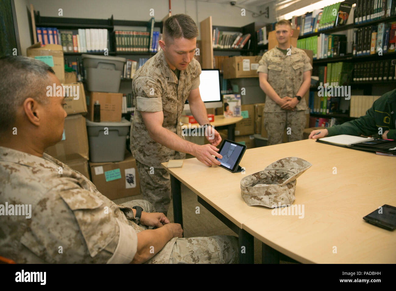 Pfc. Wesley Sweeney, volunteer, Combat Center Library, demonstrates the ...