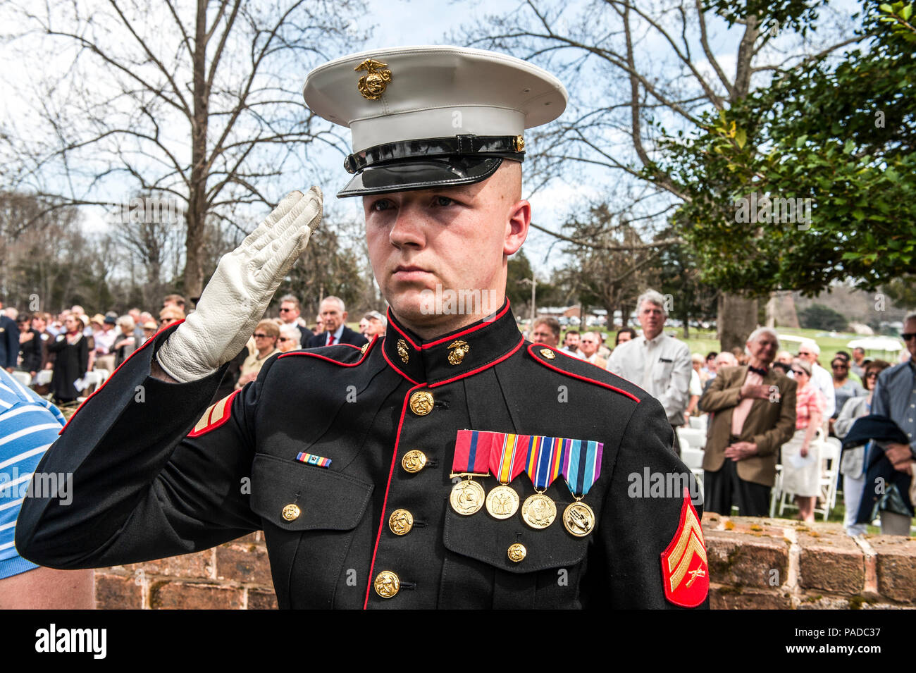U.S. Marine Cpl. Timothy Willer renders honors during Taps at the James ...
