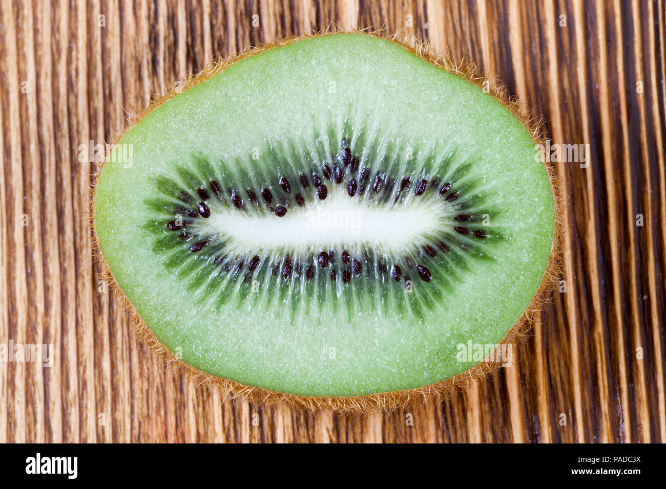 the core of ripe green kiwi lying on a wooden table, close-up Stock ...