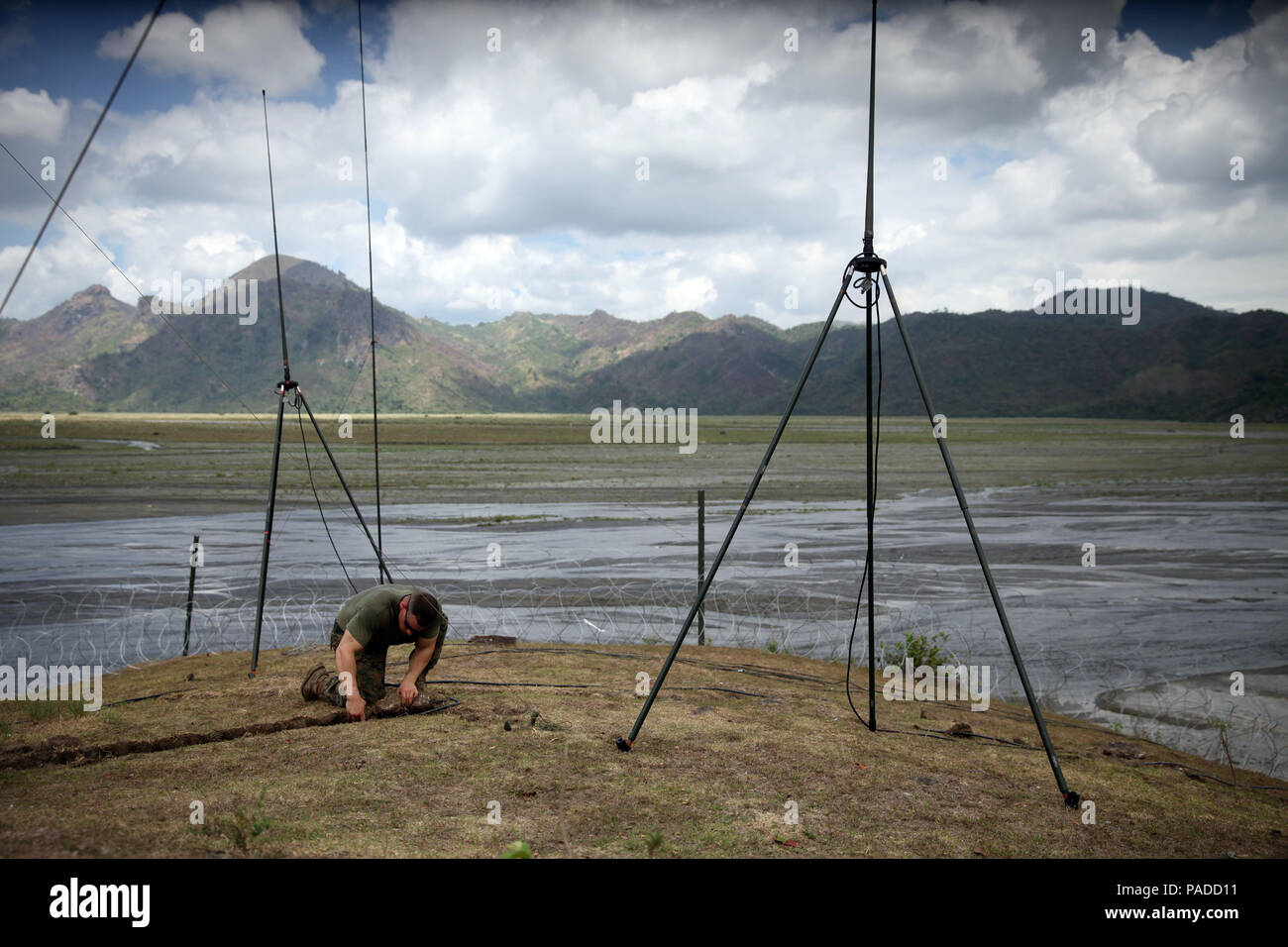 U.S. Marine Sgt. Deven Turner buries communications wires in ...