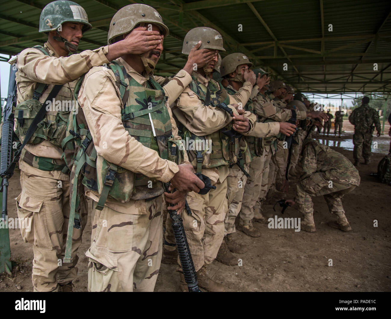 Iraqi soldiers enrolled in the Iraqi Ranger Course apply tourniquets ...