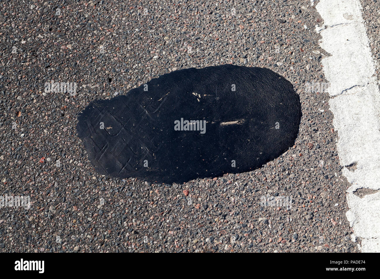 large black oily stain on the asphalt roadway, closeup Stock Photo - Alamy