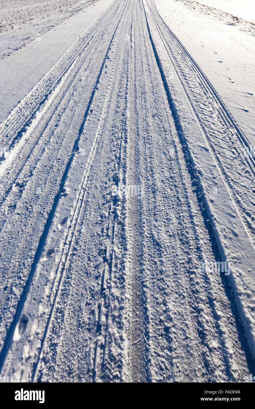 snow-covered road in the winter season, Close-up photo Stock Photo - Alamy