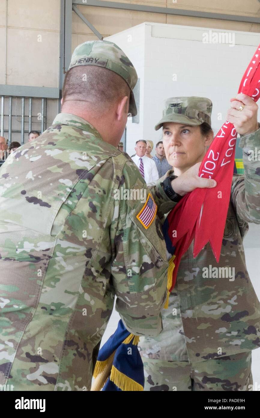 Maj. Gen. Samuel L. Henry, commander, 36th Infantry Division, hands the ...