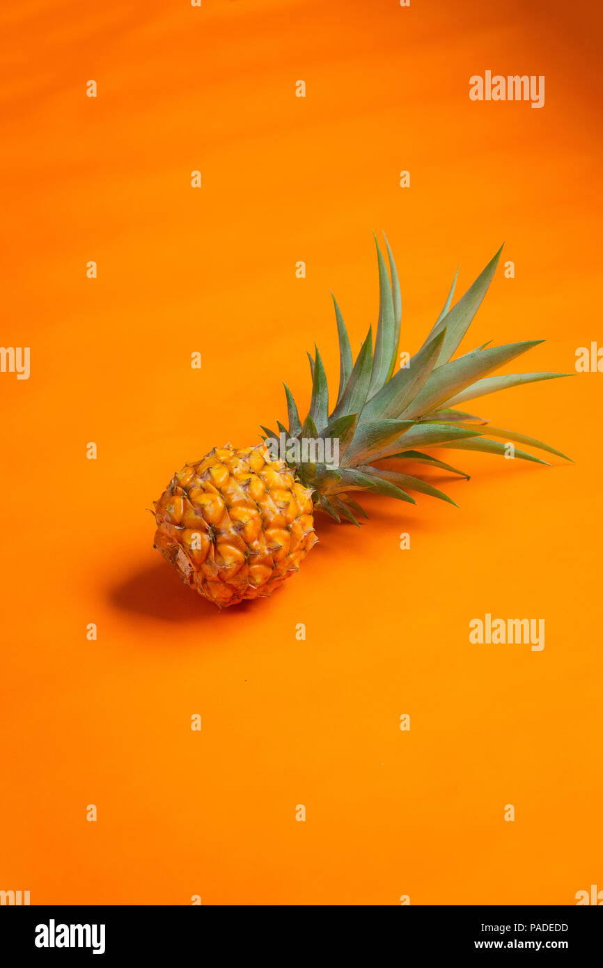 Fresh Pineapple In the orange background Stock Photo - Alamy