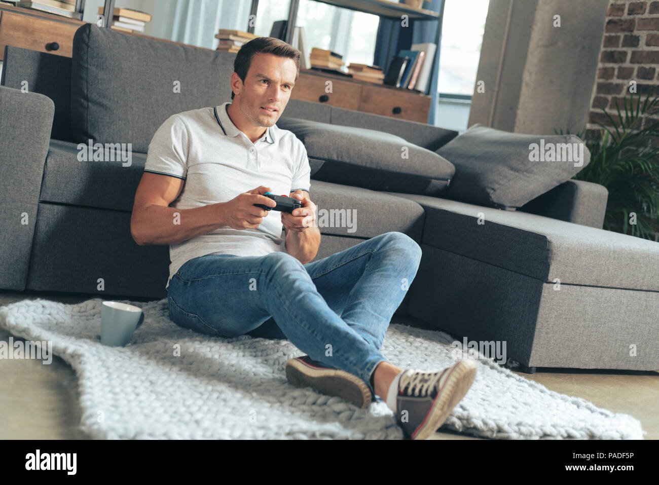 Nice handsome man playing at home Stock Photo - Alamy