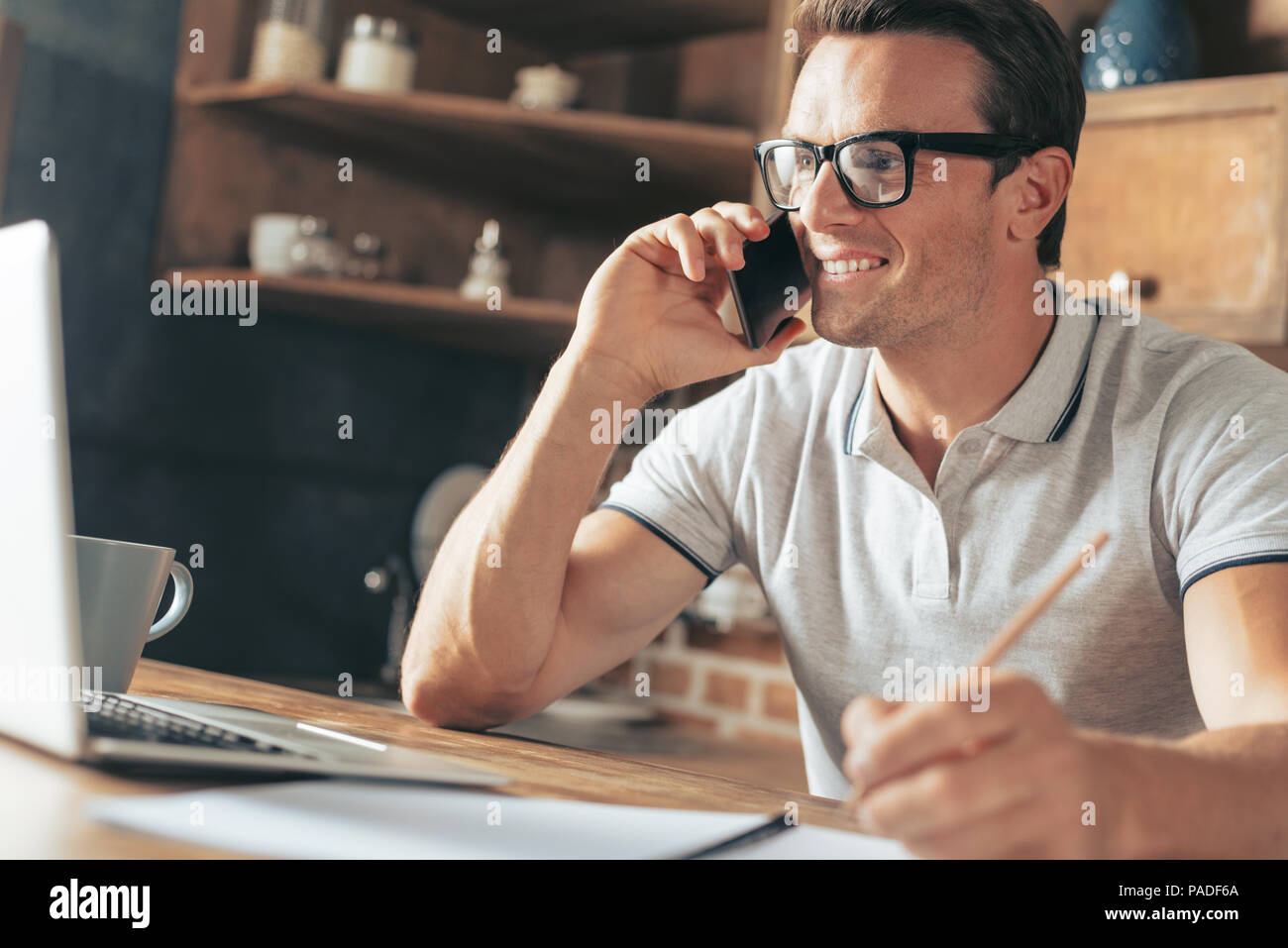 Happy handsome man making a call Stock Photo - Alamy