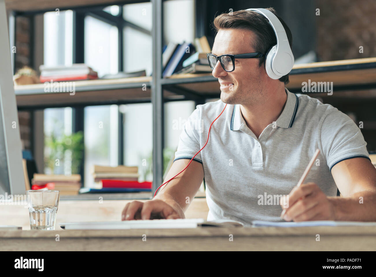Positive smart man taking notes Stock Photo - Alamy