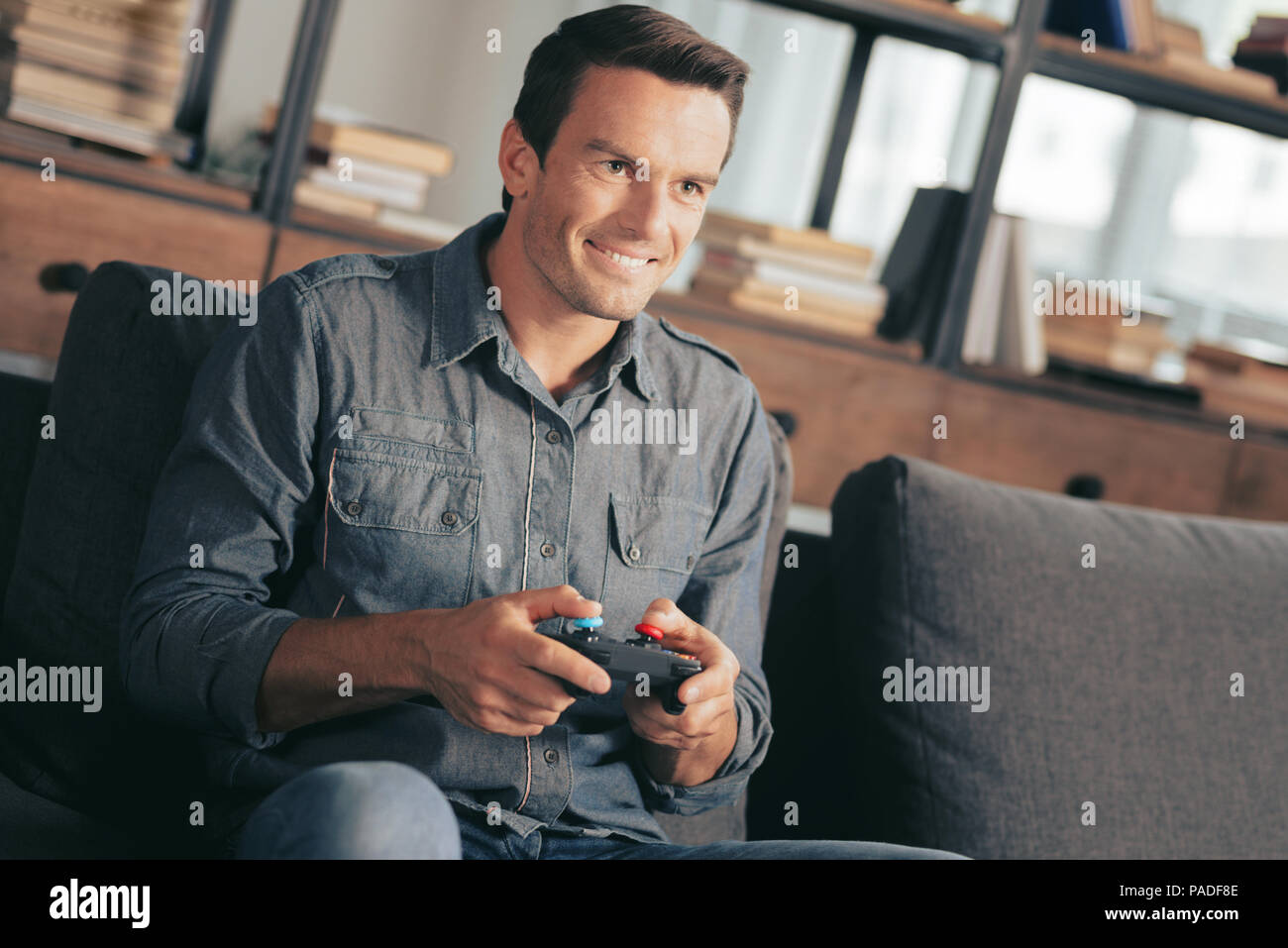 Happy nice man relaxing at home Stock Photo - Alamy