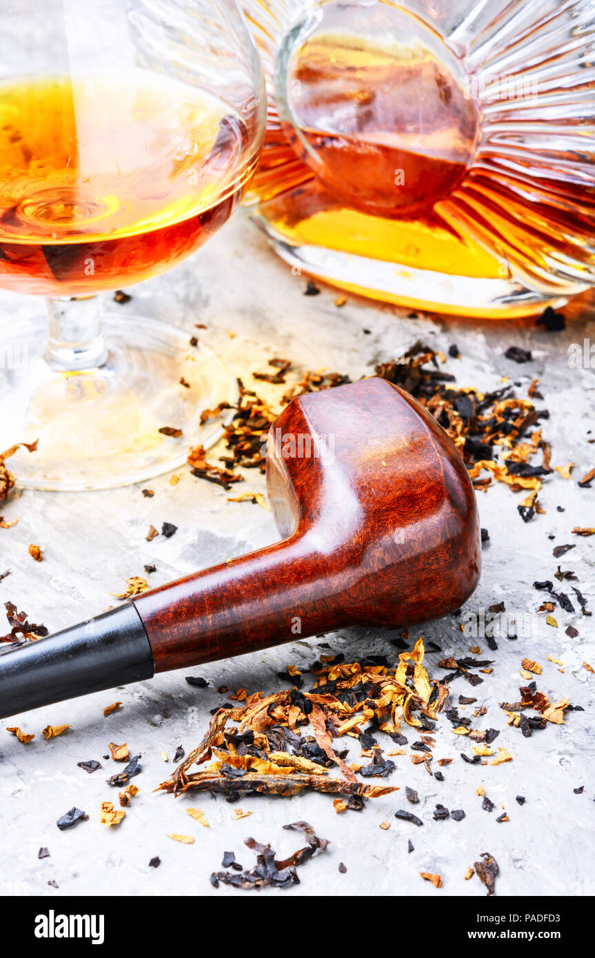 Glass of cognac and pipe with tobacco Stock Photo - Alamy