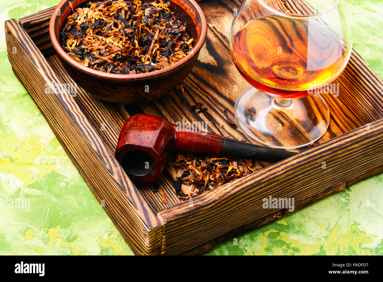 Glass of cognac and pipe with tobacco Stock Photo - Alamy