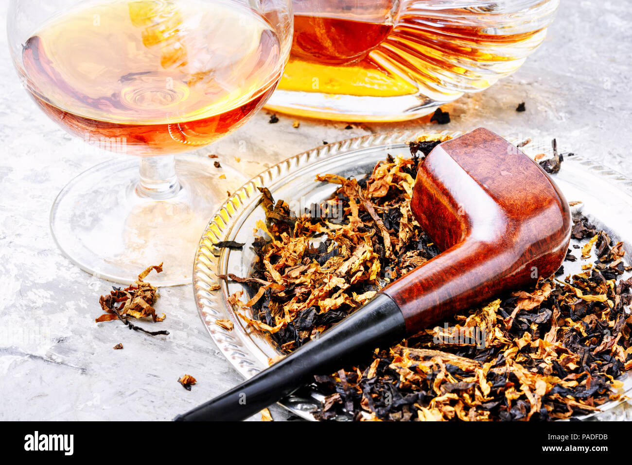 Glass of cognac and pipe with tobacco Stock Photo - Alamy