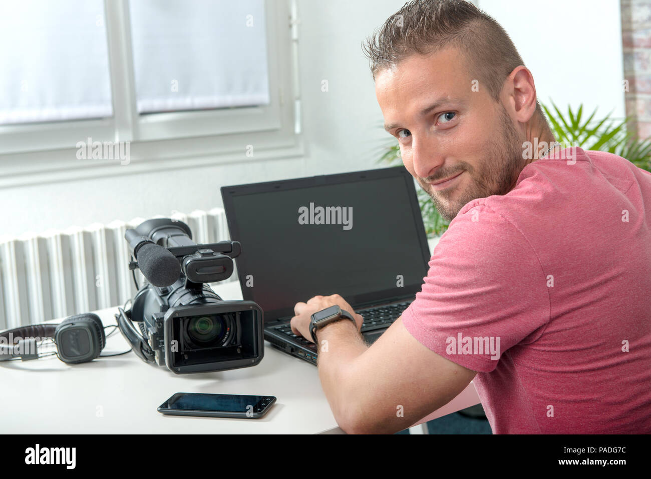 a video editor with computer and professionnal video camera Stock Photo ...