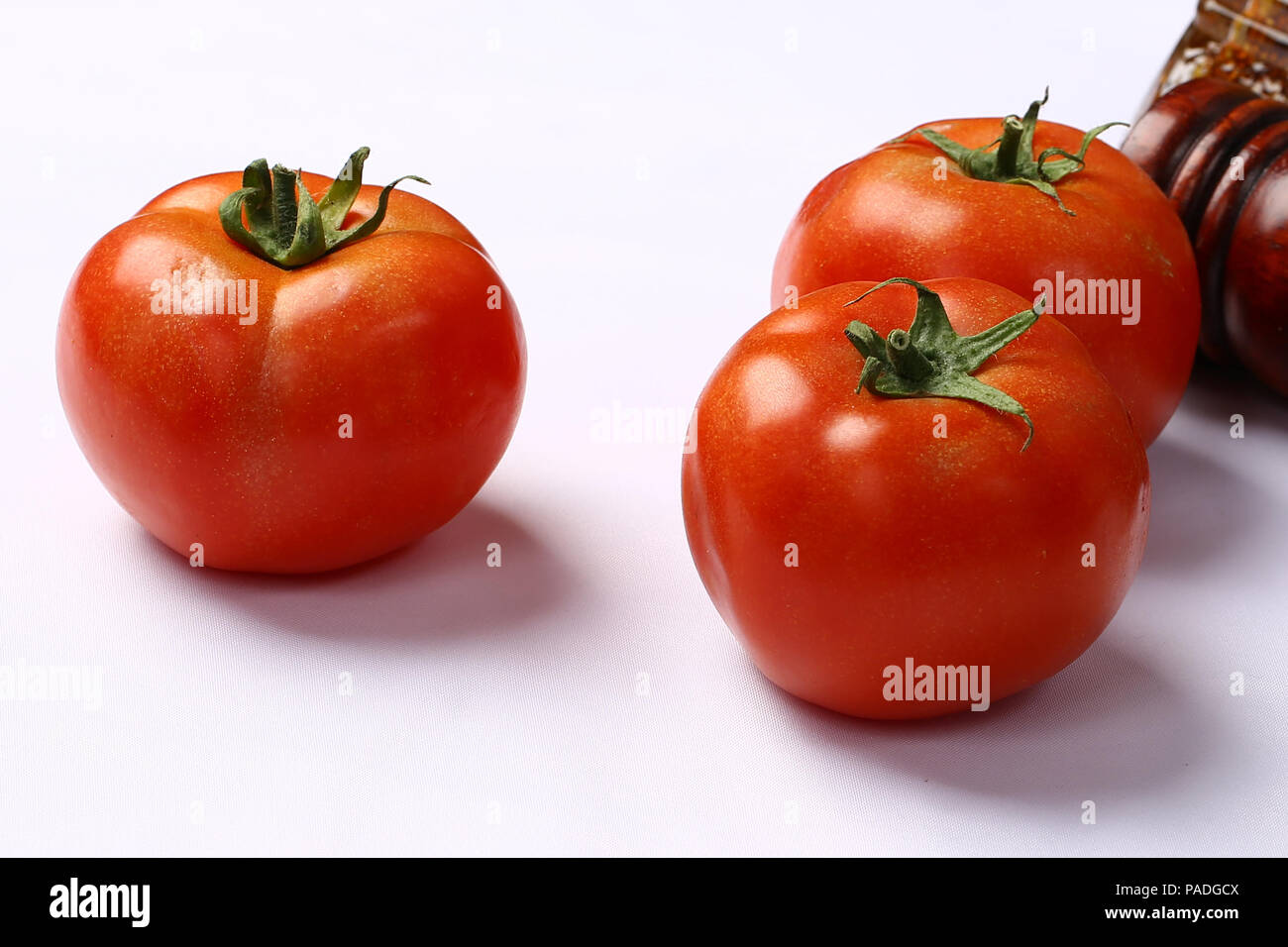 Three tomatoes isolated on a white background Stock Photo - Alamy