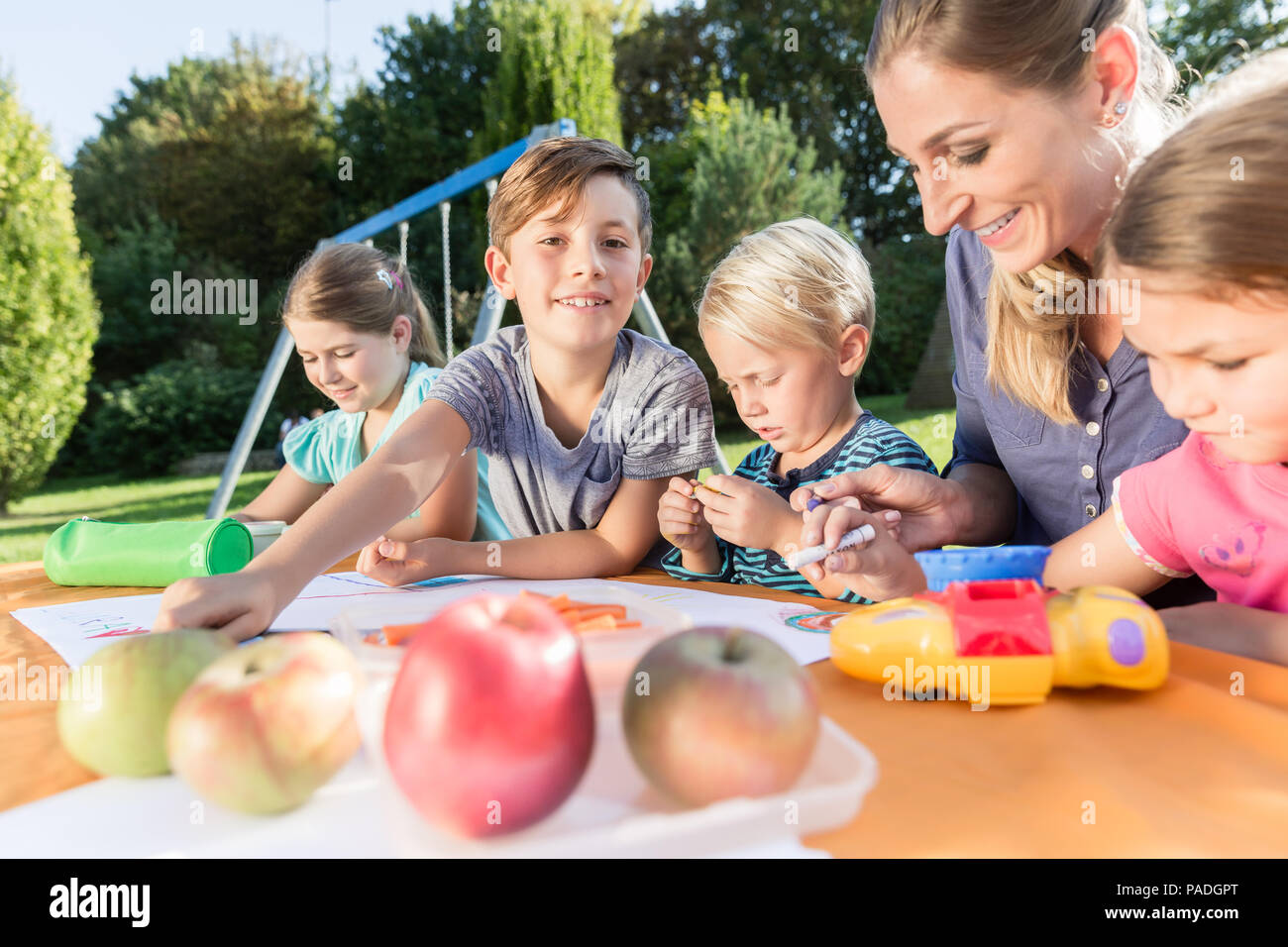 Mum painting pictures with their children and during lunch break Stock ...