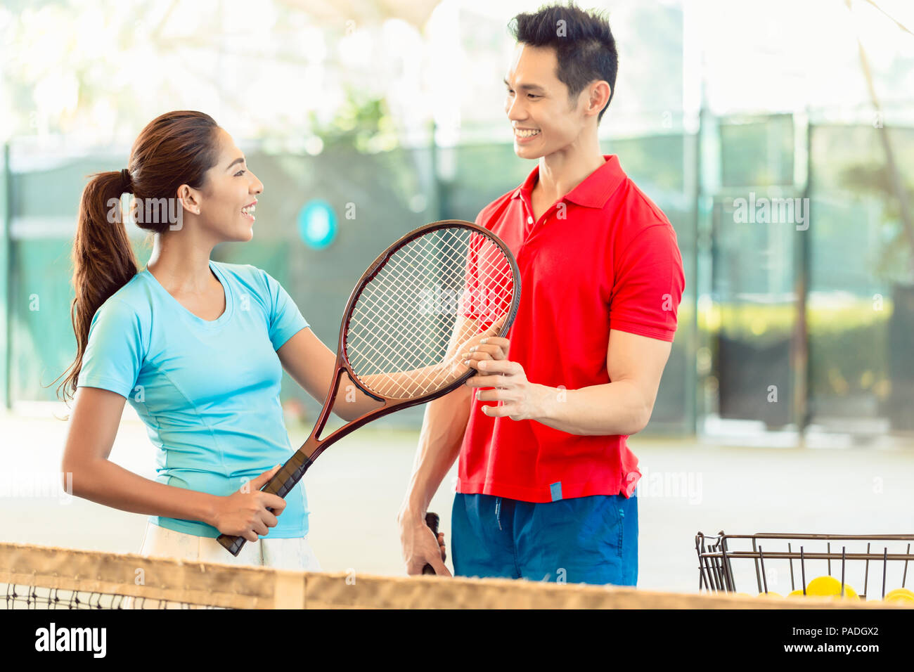 Tennis Instructor Teaching A Beginner Player The Correct Grip Stock