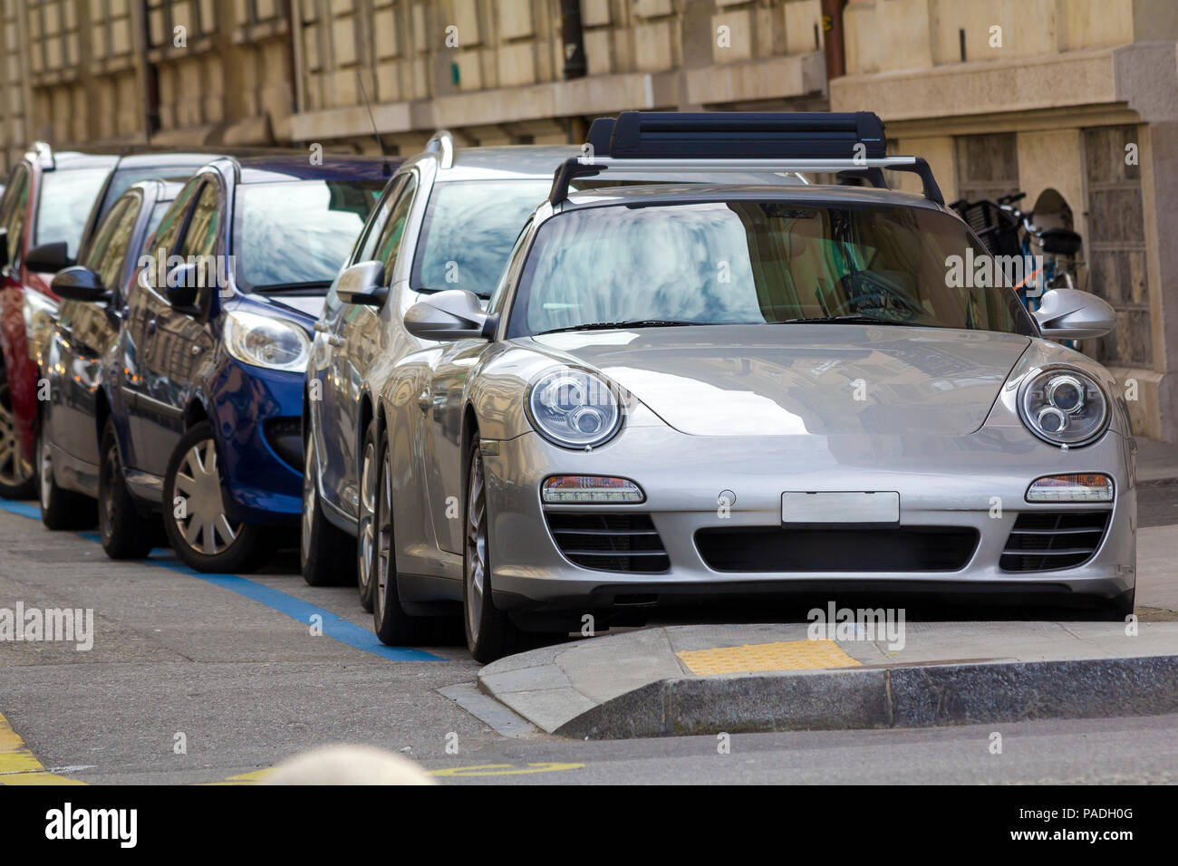 Long row of new shiny expensive luxurious cars parked along urban ...