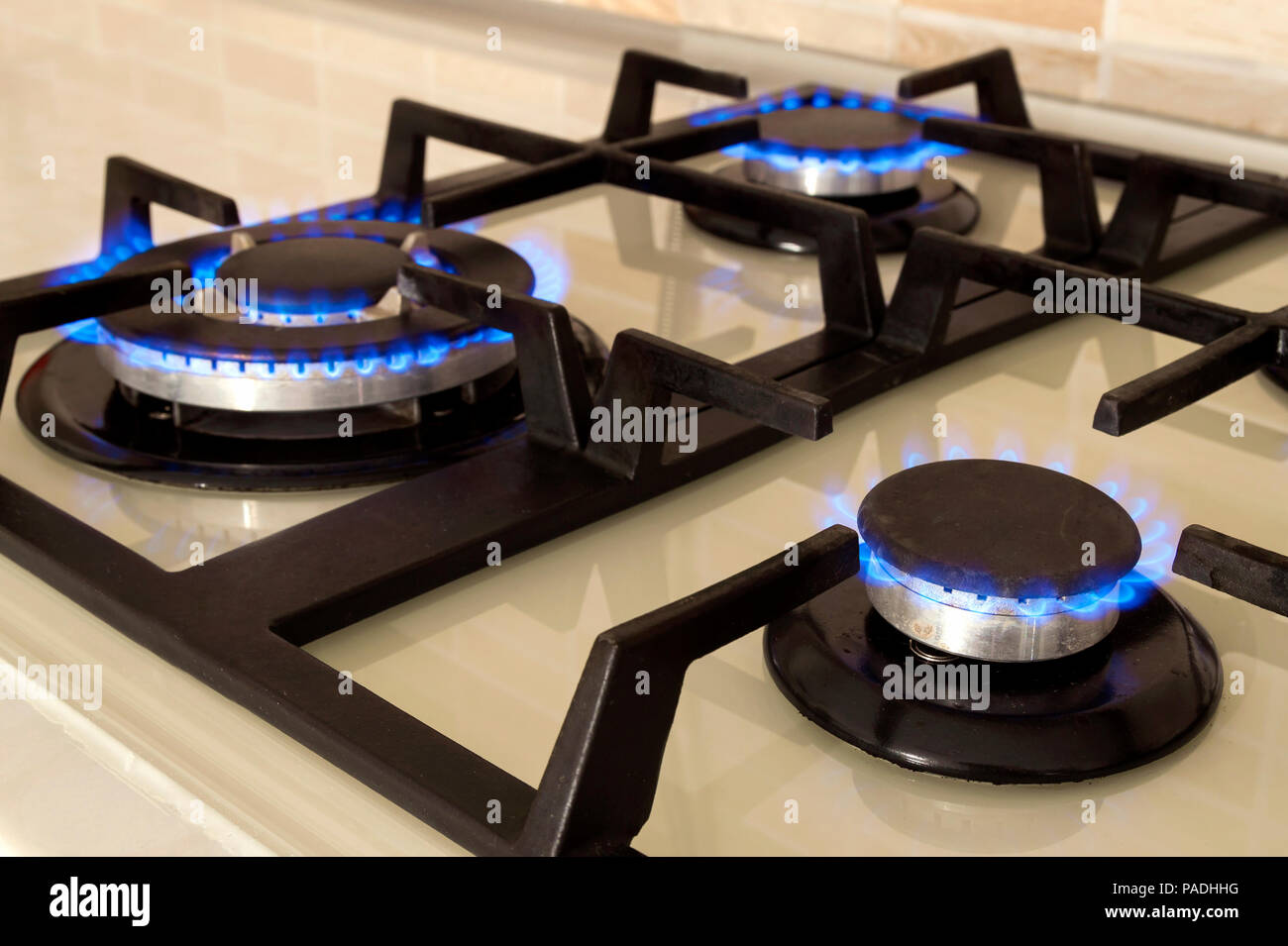 Closeup shot of blue fire from domestic kitchen stove top. Gas cooker ...