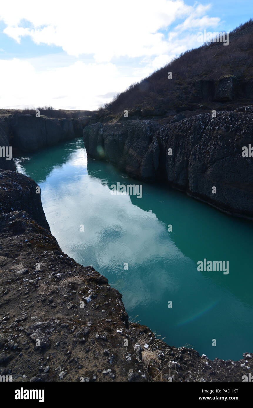 Blue river flowing through a beautiful Icelandic landscape Stock Photo ...