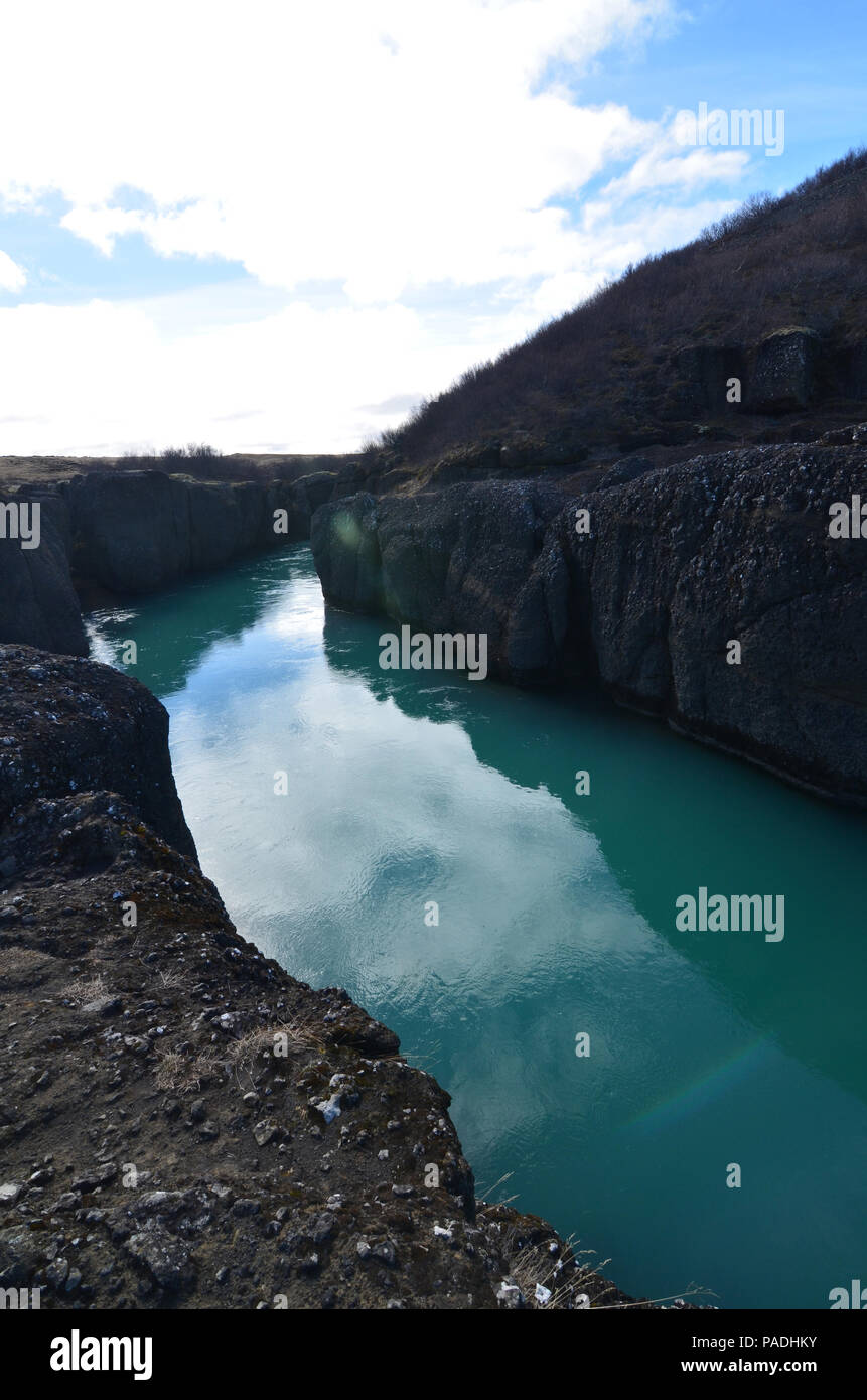 Cool river flowing through large rocks in Iceland Stock Photo - Alamy