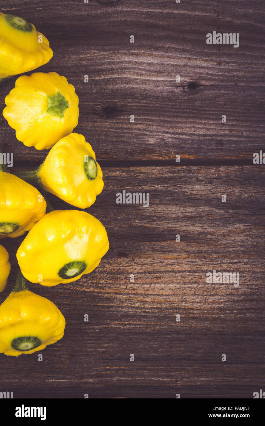 small size patty pan patisson squash wood background Stock Photo - Alamy