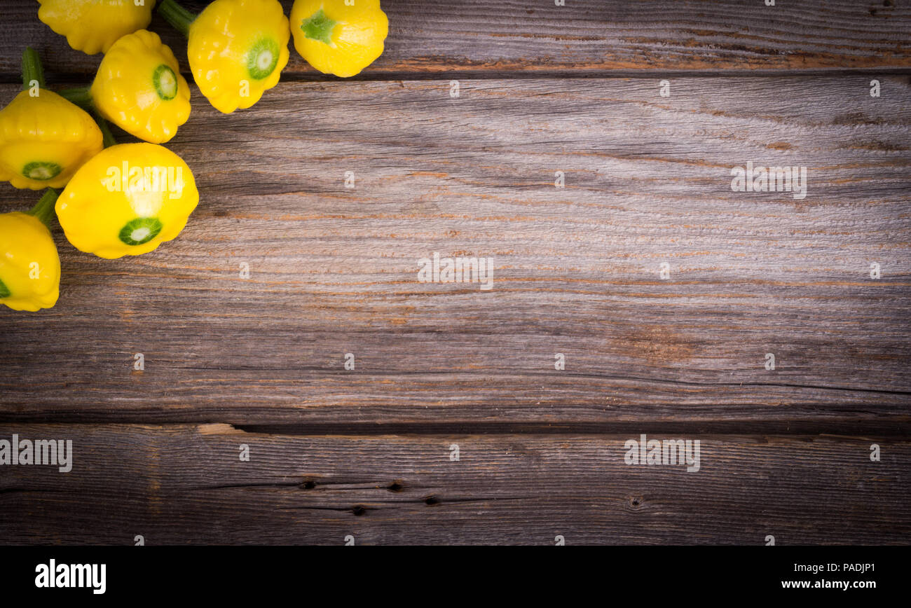 small size patty pan patisson squash wood background Stock Photo - Alamy