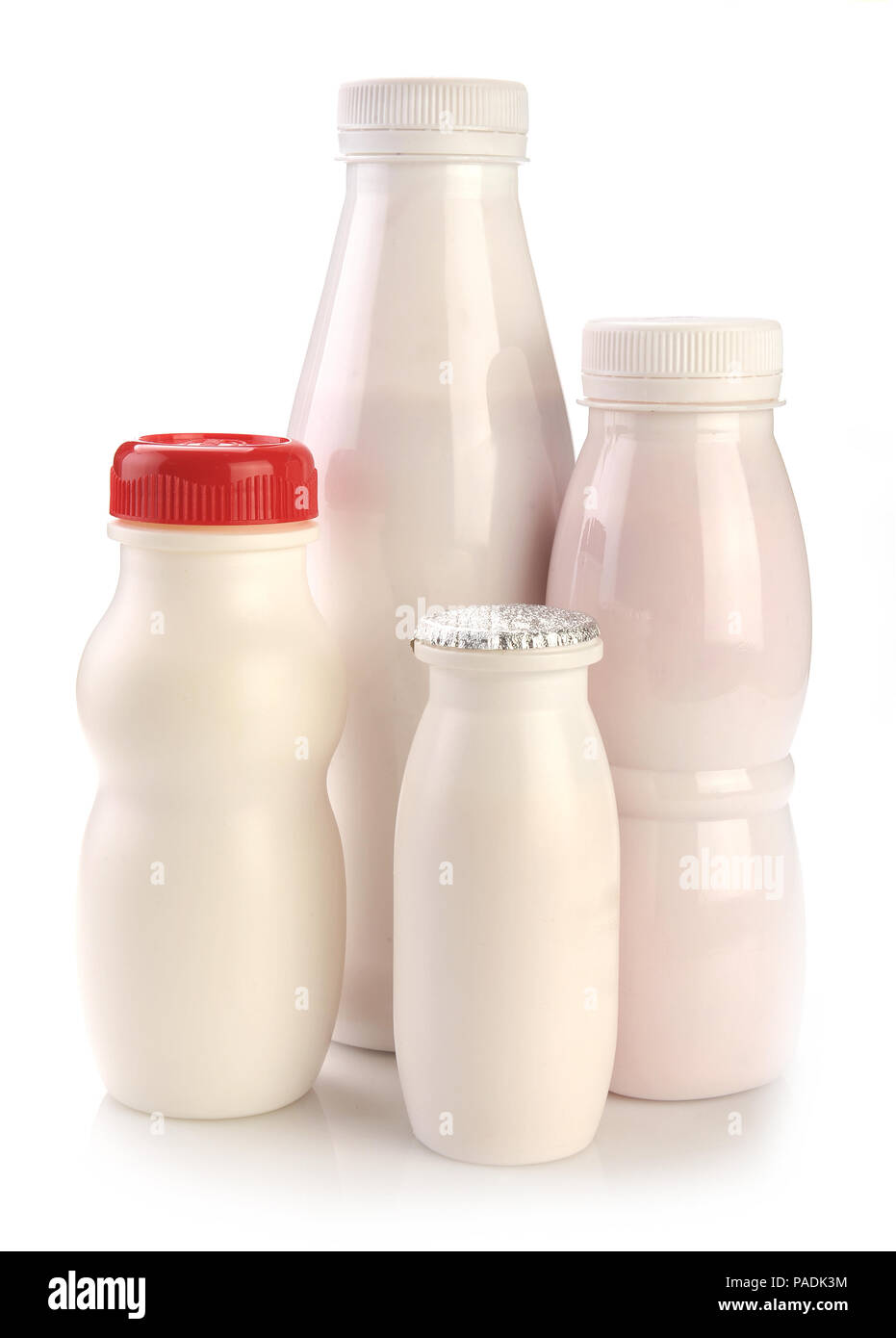 Various bottles of yogurt on a white background Stock Photo - Alamy