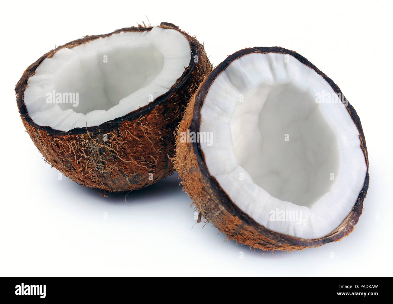 two halves of a coconut on white background Stock Photo - Alamy