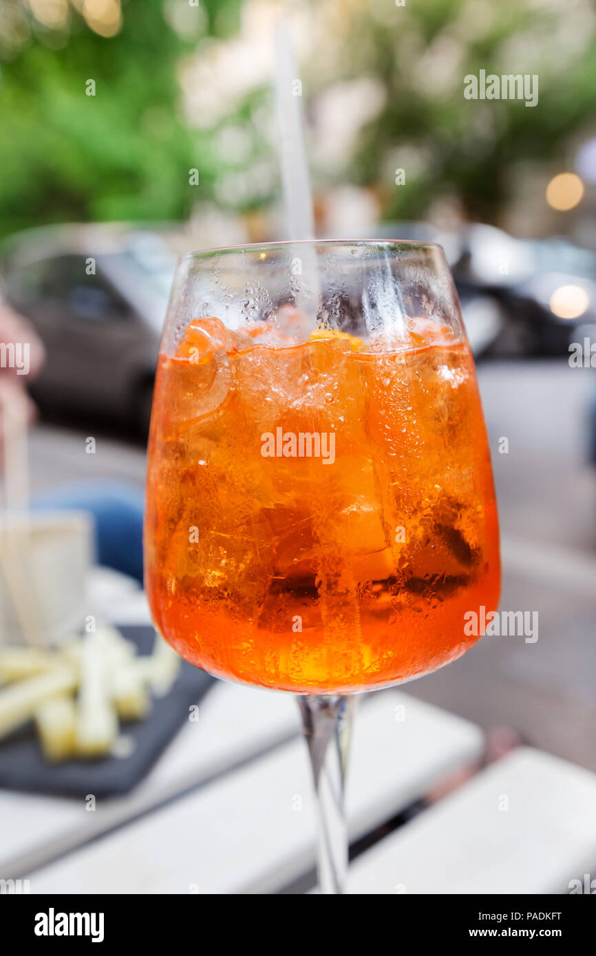 Glass of Aperol Spritz cocktail on the table in restaurant, famous ...