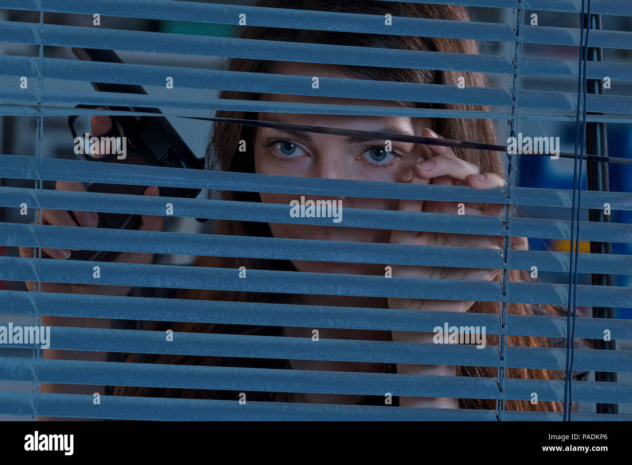 young woman with a gun at the window Stock Photo - Alamy