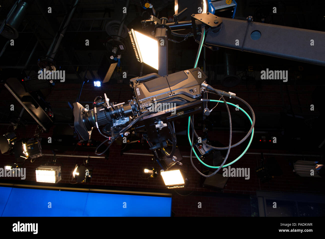 TV digital professional camera on crane shooting TV show. Spotlights in ...