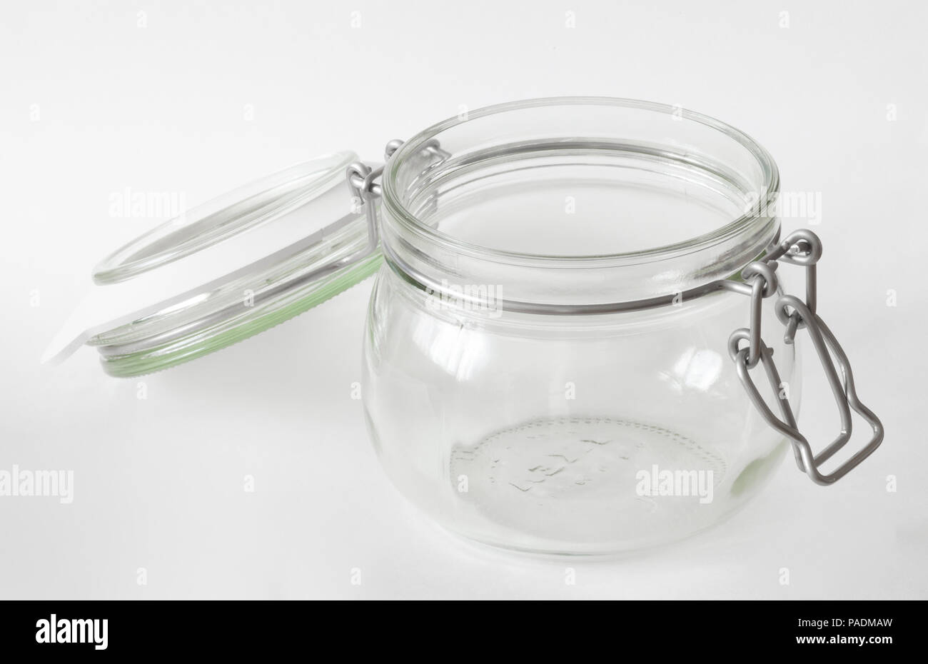 Glass jar with opened lid isolated on white Stock Photo - Alamy