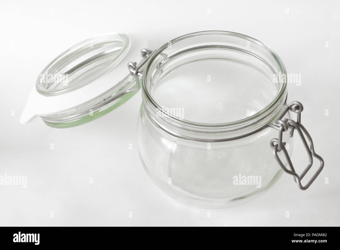Glass jar with opened lid isolated on white Stock Photo - Alamy