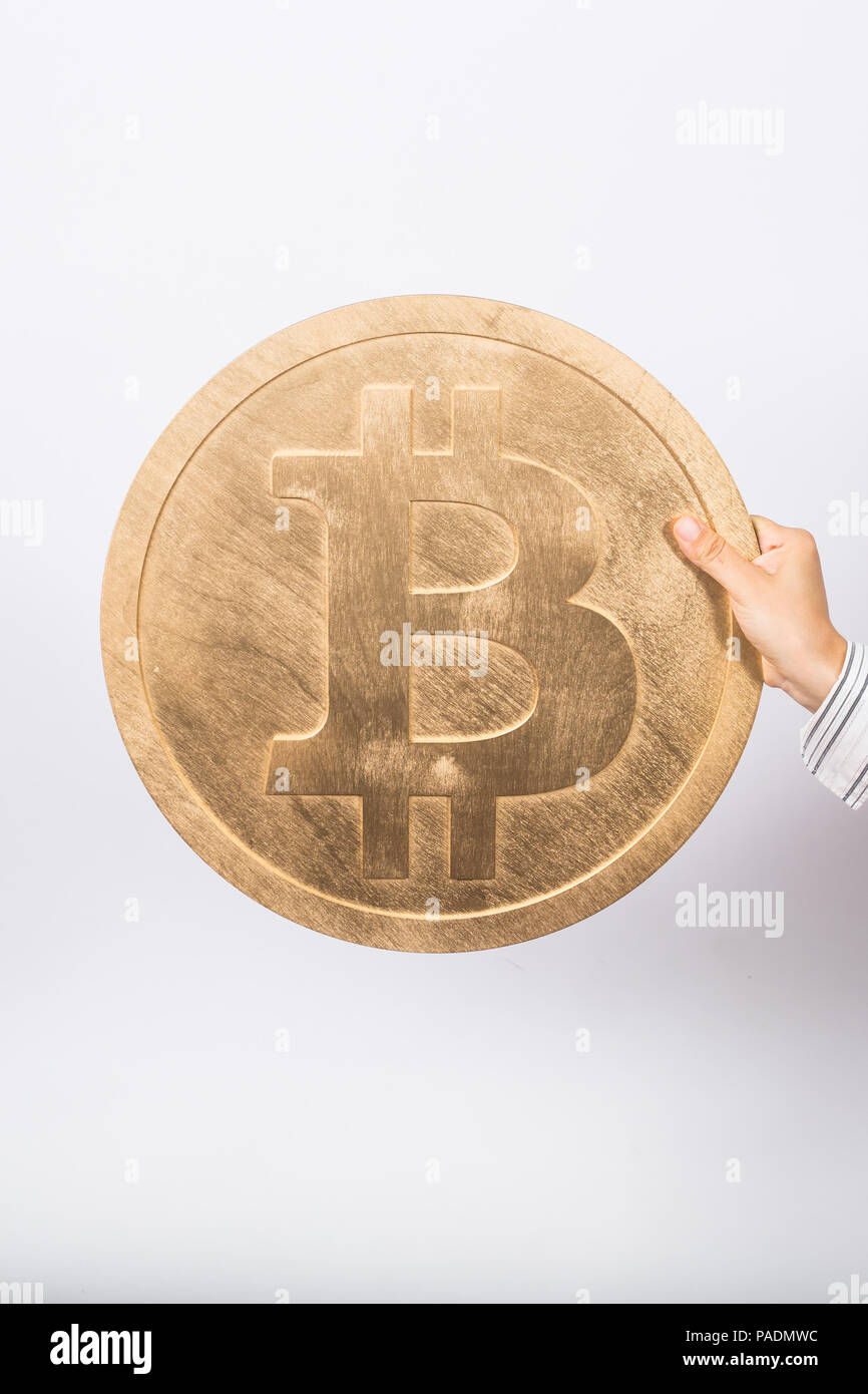 Big bitcoin in hand on white background. Virtual money, crypto currency ...